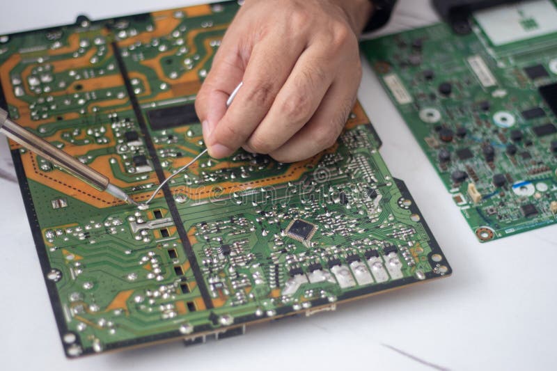 Technician Using a Soldering Iron To Repair a Circuit Board Stock Photo ...