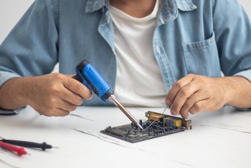 Technician Using a Soldering Iron To Repair a Circuit Board Stock Photo ...