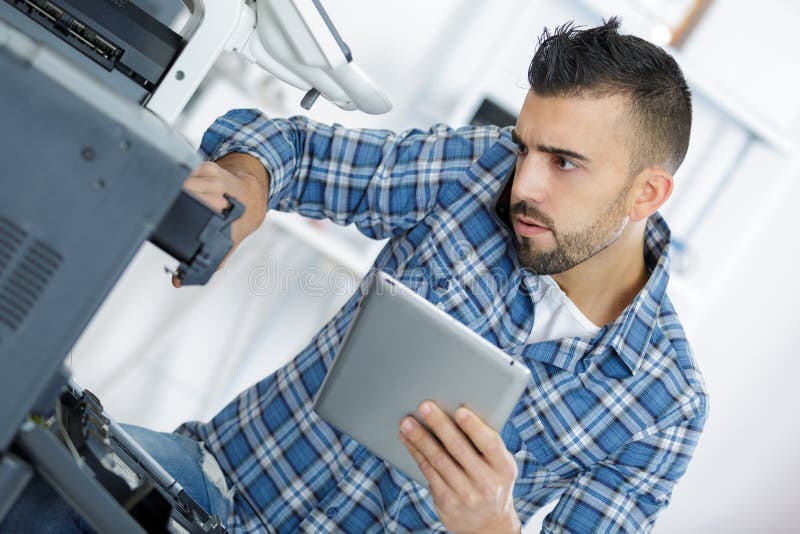 Technician Using Tablet To Fix Printer Stock Photo - Image of ...