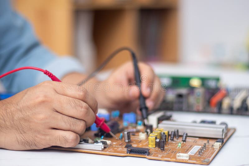 Technician Using Tool To Measure Circuit Board, Check and Repair Stock ...