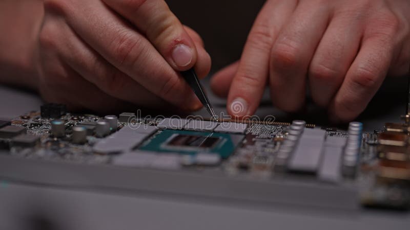 Technician Using Tweezers Applying New Thermal Pads To GPU of Modern ...