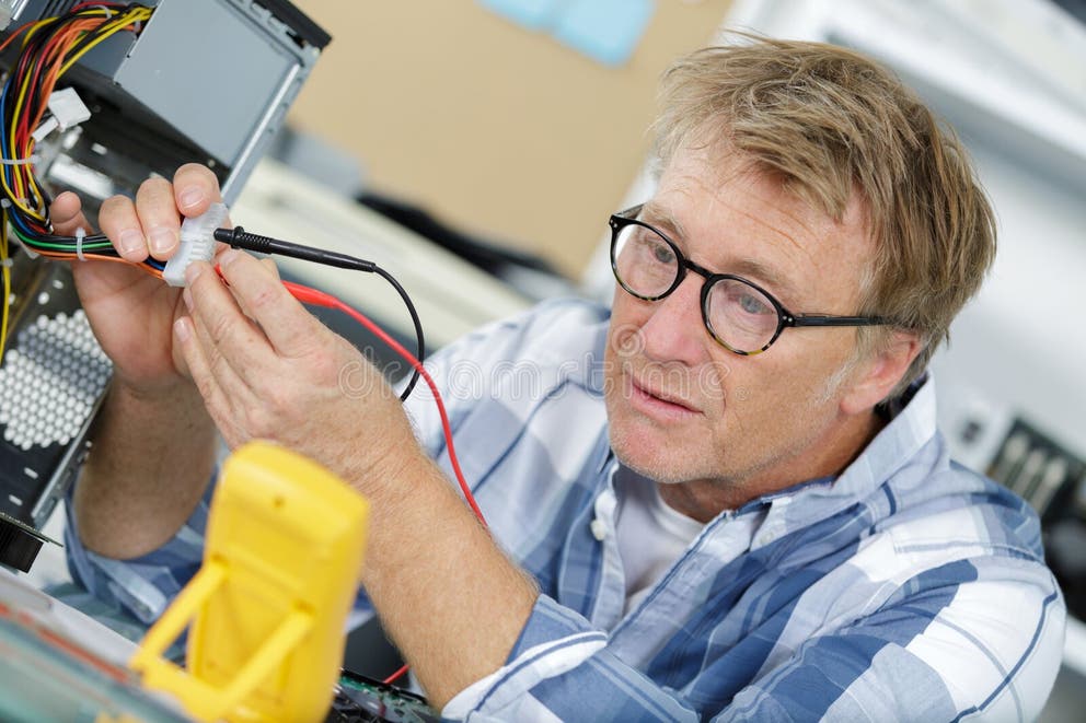 Technician Using Voltage Meter for Voltage Measurement in Computer ...