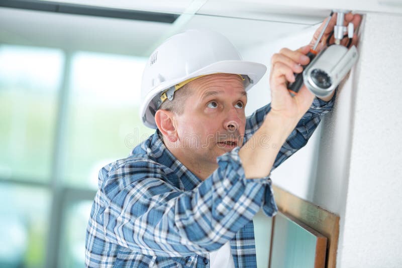 Technician Worker Installing Video Surveillance Camera on Wall Stock ...