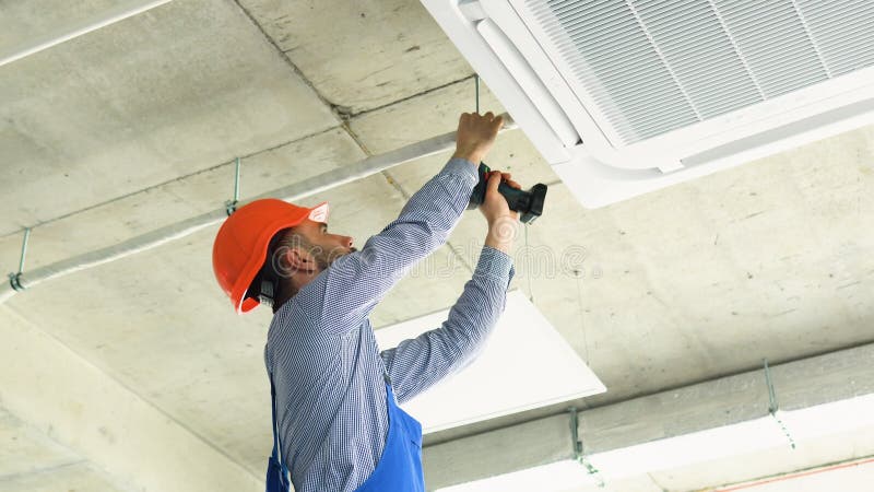 Technician Worker Installs Air Conditioning System at Office Stock ...