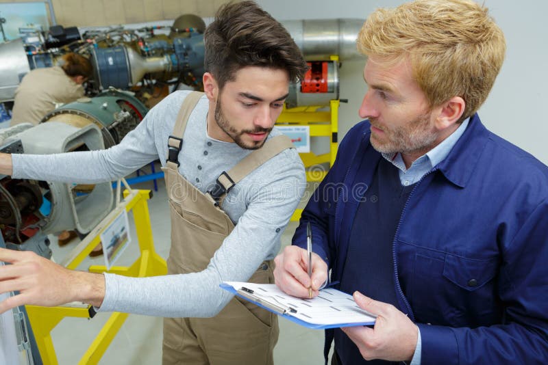 Technician Working with Apprentice Stock Photo - Image of clipboard ...