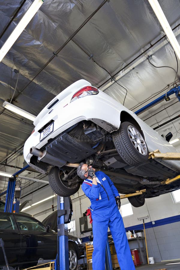 Technician Working on Car at Automobile Repair Shop Stock Photo - Image ...