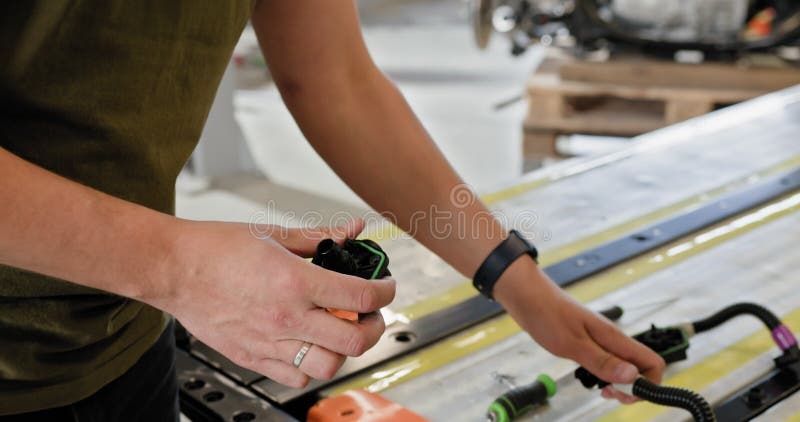 Technician Working on Electric Car Battery in Workshop Stock Footage ...