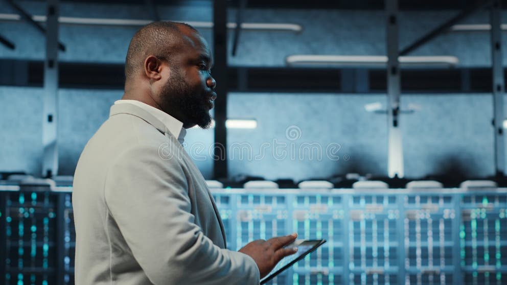 Technician Working in High Tech Server Hub, Analyzing Data on Tablet ...