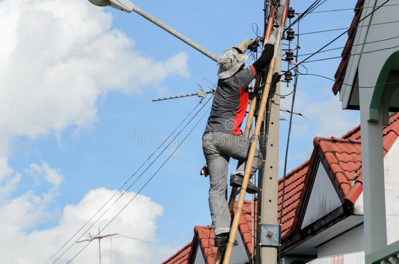 Technician working on pole stock photo. Image of installing - 99624688