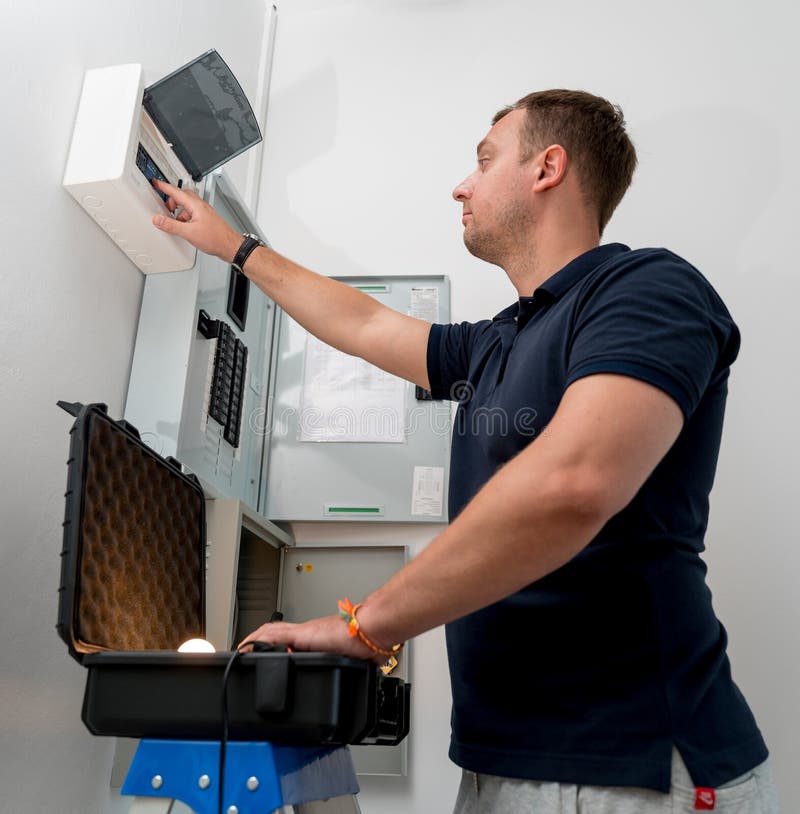 A Technician Works with a Demo Kit of the Smart Home System Stock Image ...