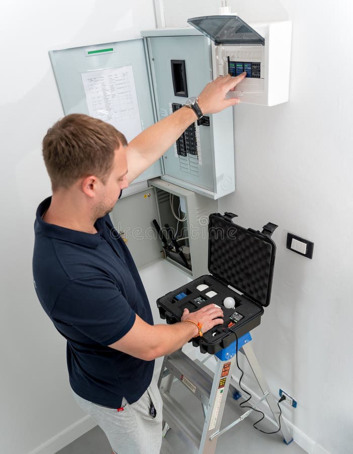 A Technician Works with a Demo Kit of the Smart Home System Stock Image ...