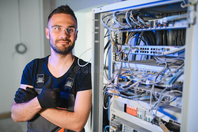 A Technician Works with Server Equipment in a Data Center. a Man ...