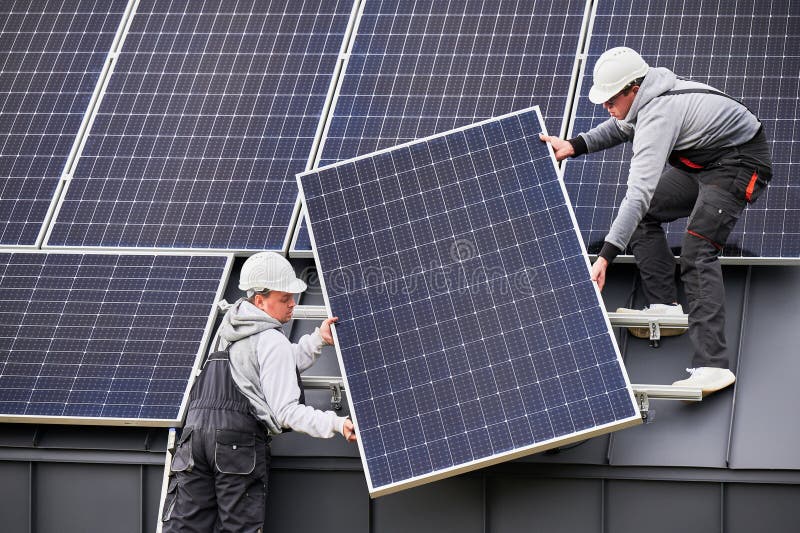 Technicians Carrying Photovoltaic Solar Module while Installing Solar ...