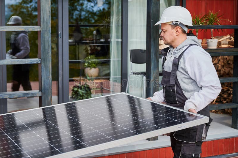 Technicians Carrying Photovoltaic Solar Module while Installing Solar ...