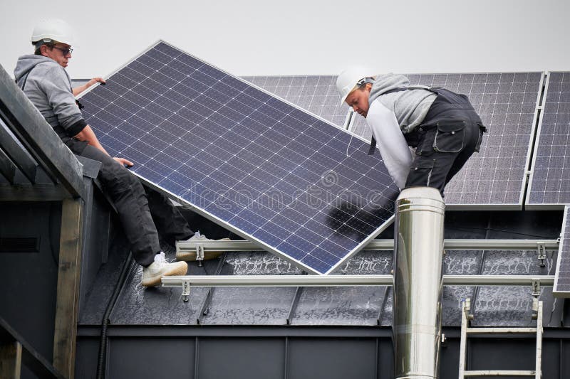 Technicians Carrying Photovoltaic Solar Module while Installing Solar ...
