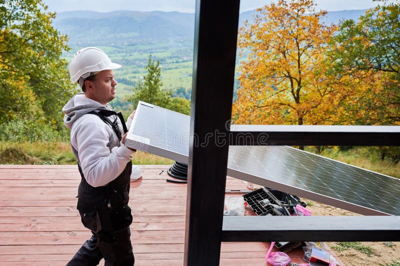 Technicians Carrying Photovoltaic Solar Module while Installing Solar ...
