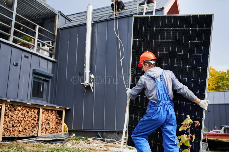 Technicians Carrying Photovoltaic Solar Module while Installing Solar ...