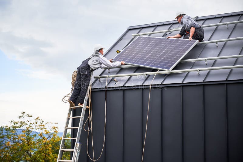 Technicians Carrying Photovoltaic Solar Module while Installing Solar ...