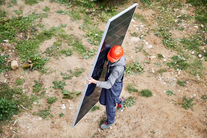 Technicians Carrying Photovoltaic Solar Module while Installing Solar ...
