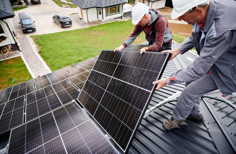Technicians Carrying Photovoltaic Solar Module while Installing Solar ...