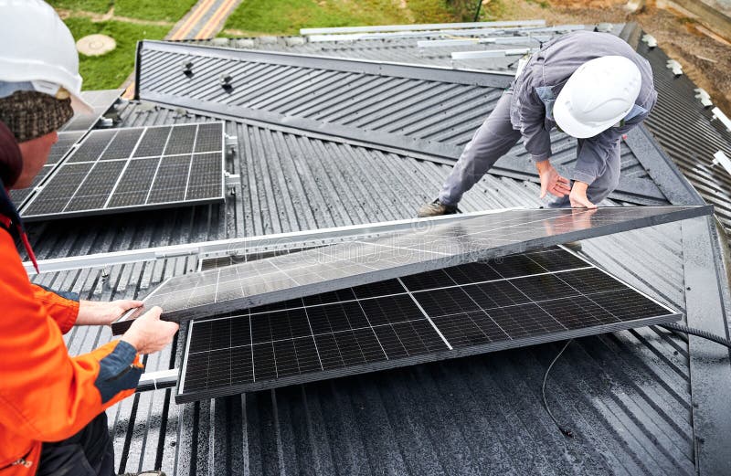 Technicians Carrying Photovoltaic Solar Module while Installing Solar ...