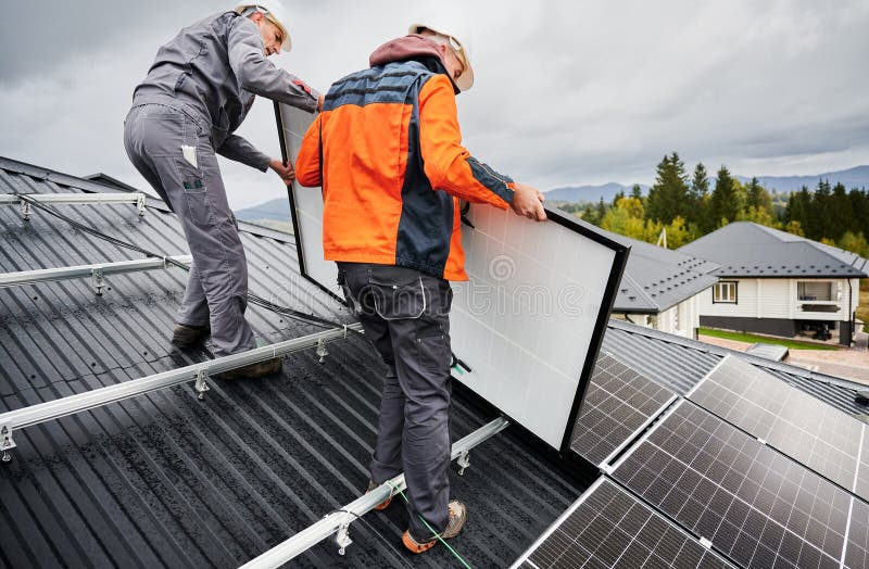 Technicians Carrying Photovoltaic Solar Module while Installing Solar ...
