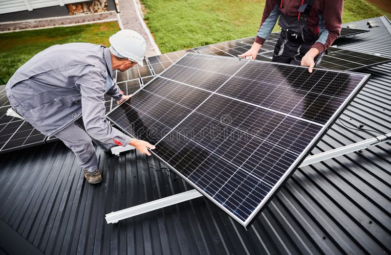 Technicians Carrying Photovoltaic Solar Module while Installing Solar ...