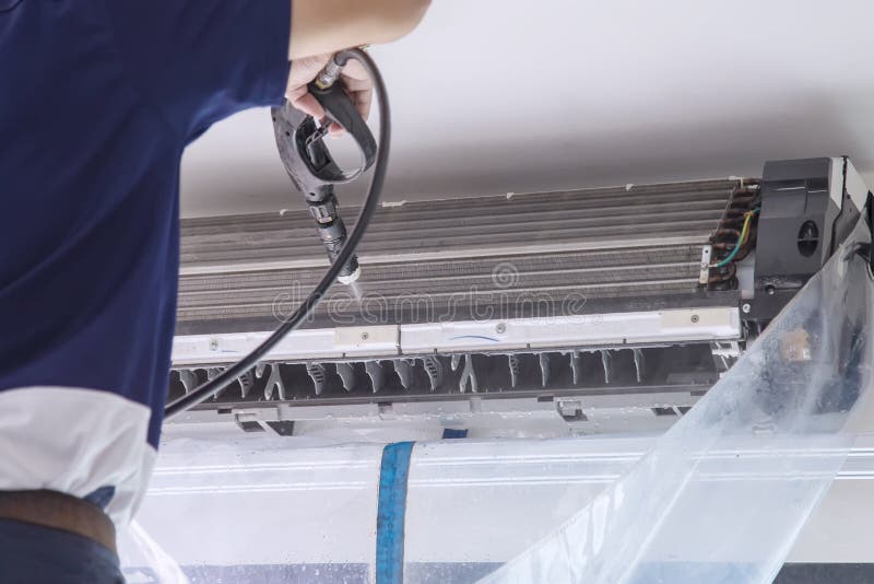 The Technicians are Cleaning the Air Conditioner by Spraying Water ...