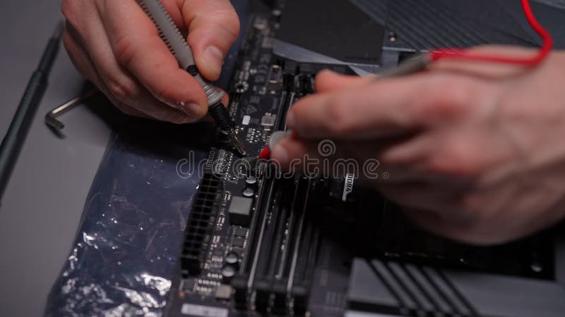 Technicians Hands Using Multimeter To Measure Voltage on Computer ...