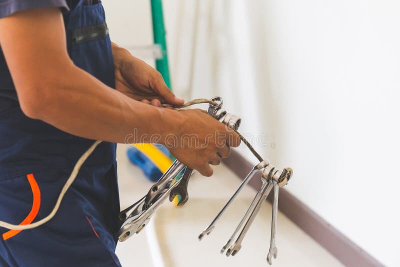 Technicians Holding Sets of Wrenches, Workers Holding Wrench Spanners ...