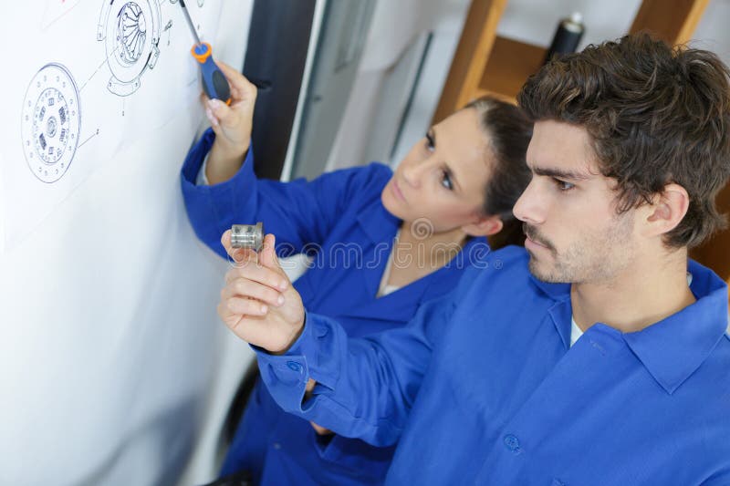 Technicians Identifying Part on Exploded Technical Drawing Stock Photo ...
