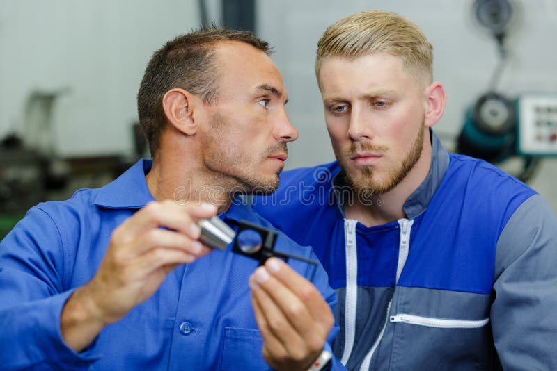 Technicians Inspecting Part Using Magnifying Glass Stock Image - Image ...