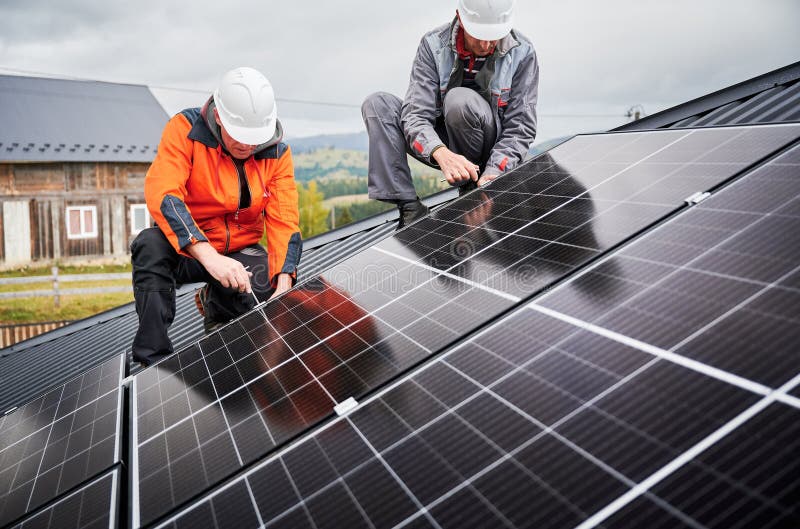 Technicians Installing Photovoltaic Solar Panels on Roof of House ...