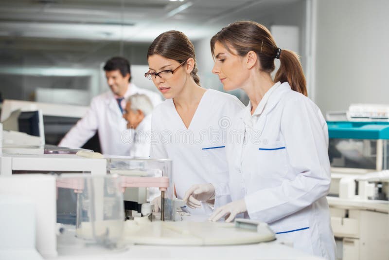 Technicians Operating Machine Stock Photo - Image of colleague ...
