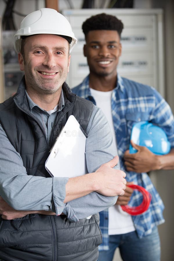 Technicians Posing Next To Fuseboard Stock Photo - Image of power ...