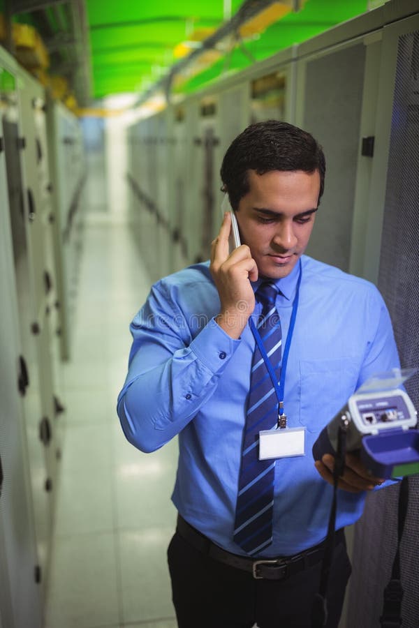 Technicians Talking on Mobile Phone while Analyzing Server Stock Photo ...