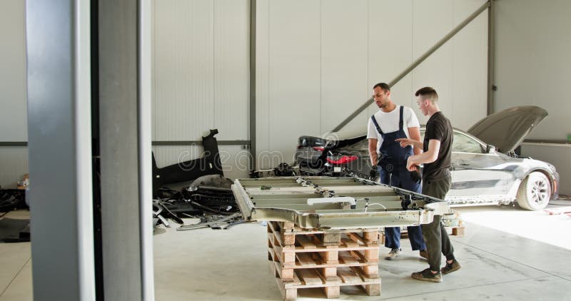 Technicians Troubleshooting EV Car Battery Module in Workshop Stock ...