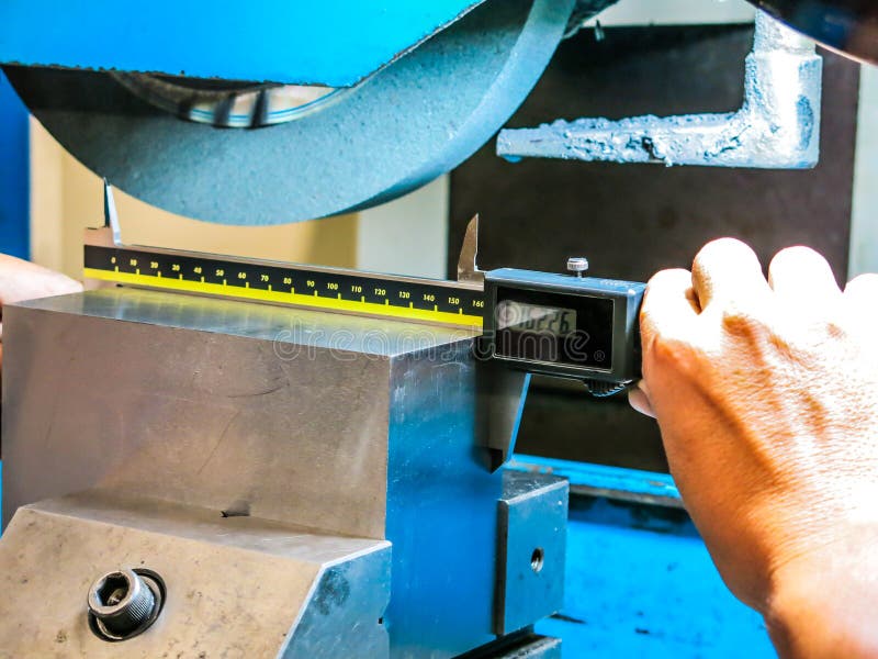 Technicians Use Digital Counters To Measure Iron Work from Grinding ...