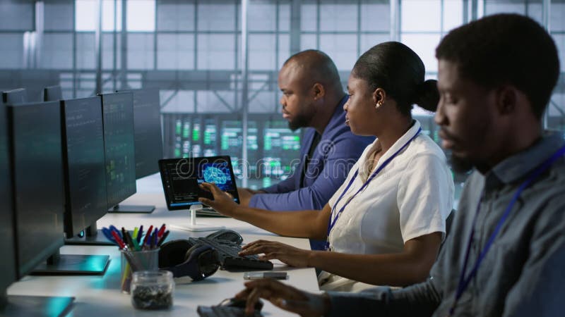Technicians Using Computers And Tablet In Data Center Implementing Ai