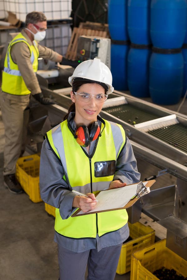 Technicians Writing in Clipboard Stock Photo - Image of factory ...