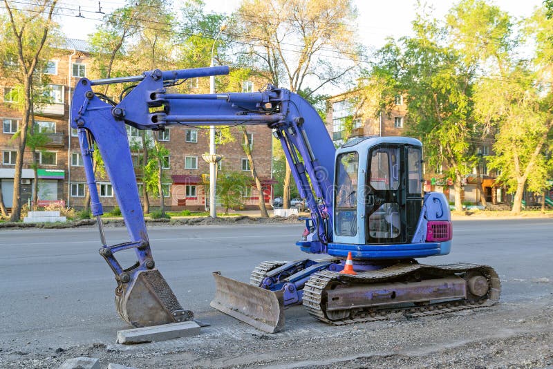 A Crawler Excavator Digs Dirt Next To a Dump Truck in Chicago Editorial ...