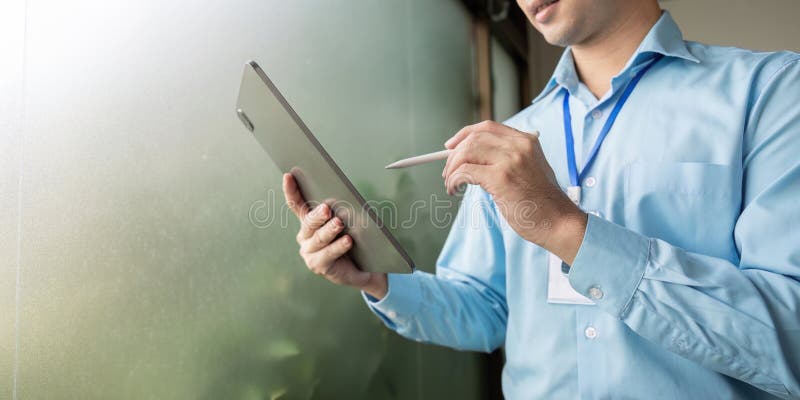 Technologically Savvy Businessman Reviewing Documents on Tablet Concept ...