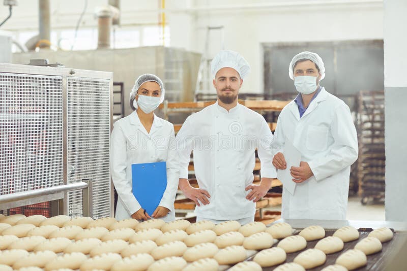 Technologist and Baker Inspect the Bread Production Line at the Bakery ...