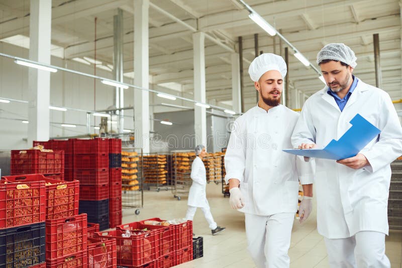 Bakers Smiling Holding Fresh Bread in Their Hands in a Bakery Stock ...