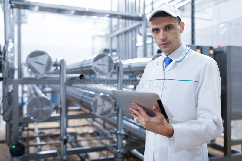 Technologist with a Tablet in His Hands at the Dairy Plant Stock Photo ...