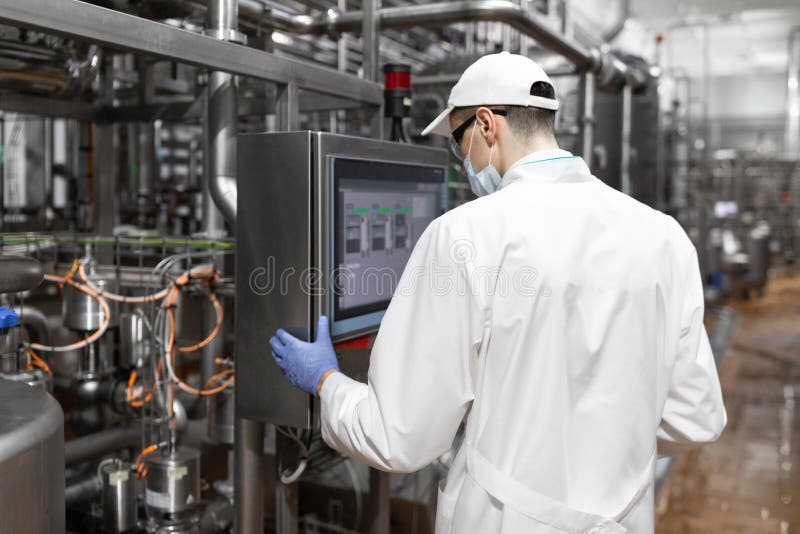 Technologist Taking Necessary Notes while Standing at Production ...