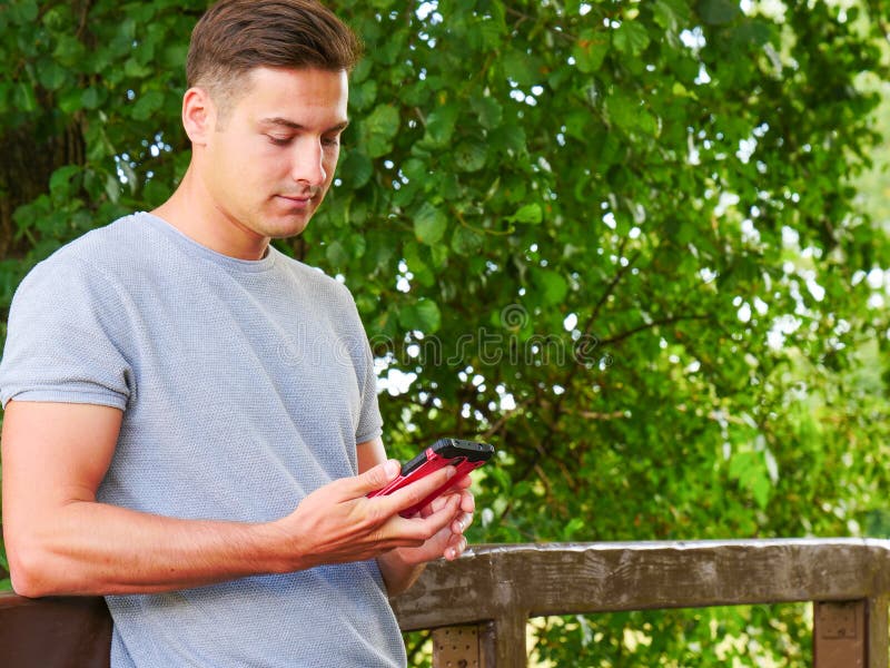 Man Using Mobile Phone in Park Stock Photo - Image of cellphone ...