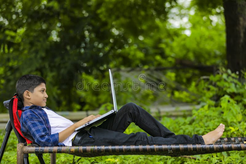 Technology Concept : Cute Indian Little School Boy Using Laptop Stock ...