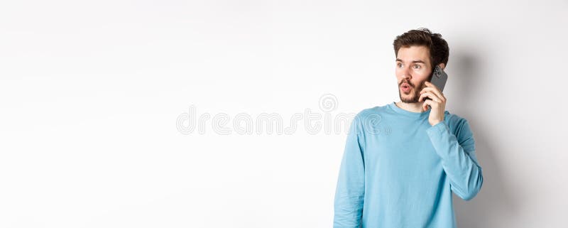 Technology Concept. Intrigued Young Man Looking Left Impressed, Talking ...