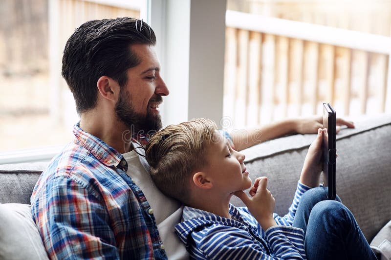 Technology Keeps Them Curious. a Little Boy Using a Digital Tablet with ...